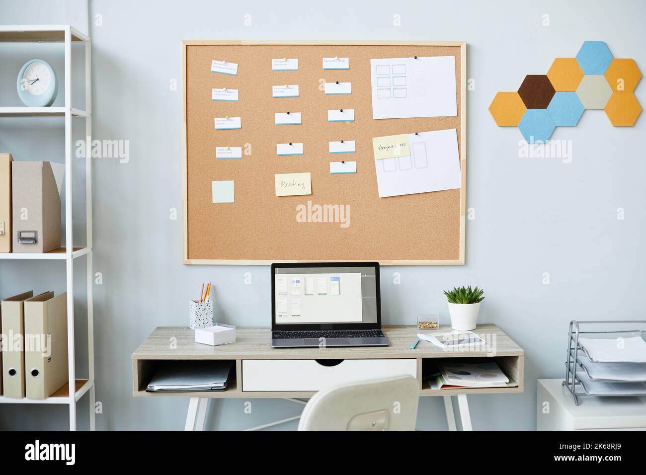 Background image of open laptop at workplace with corkboard in minimal ...