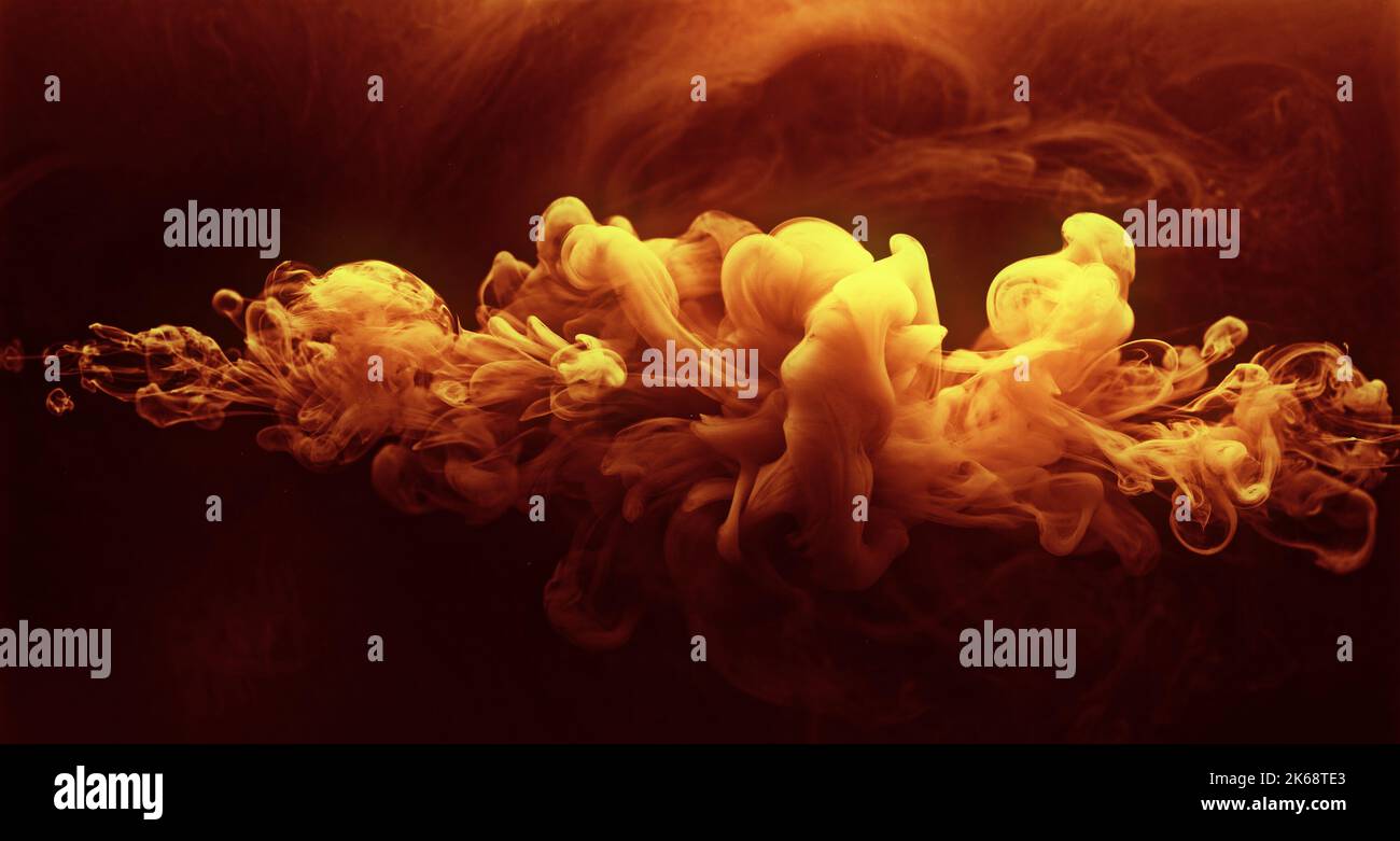 ink water blend color vapor cloud yellow red dark Stock Photo - Alamy