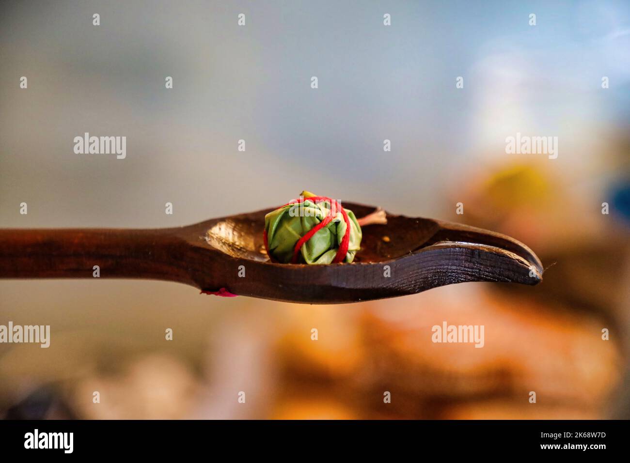 A closeup element of puja in wooden spoon, typical Indian puja on ...