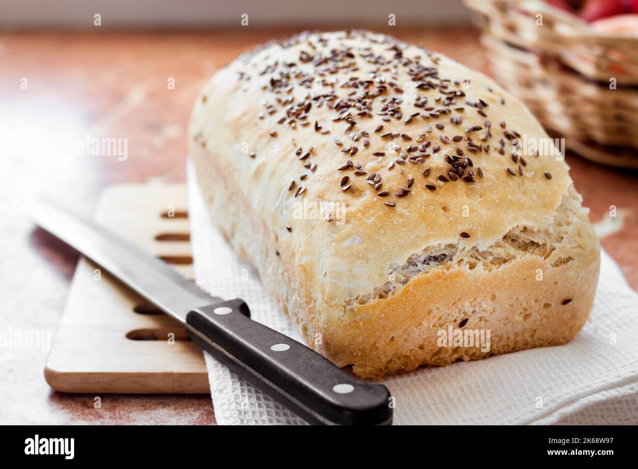 Homemade wheat bread with flax seeds on a kitchen table Stock Photo - Alamy
