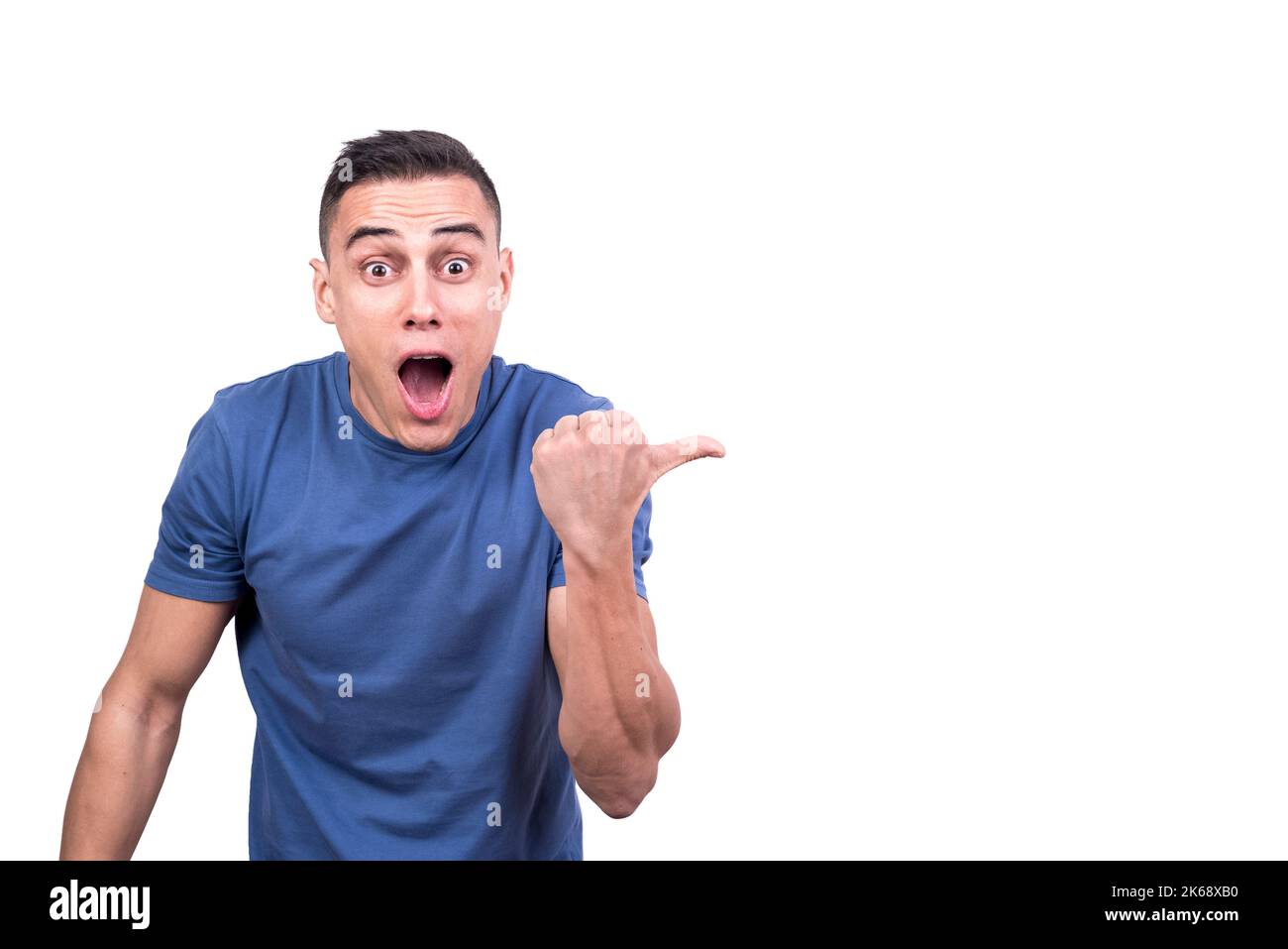 Surprised man pointing to the side with the thumb Stock Photo - Alamy