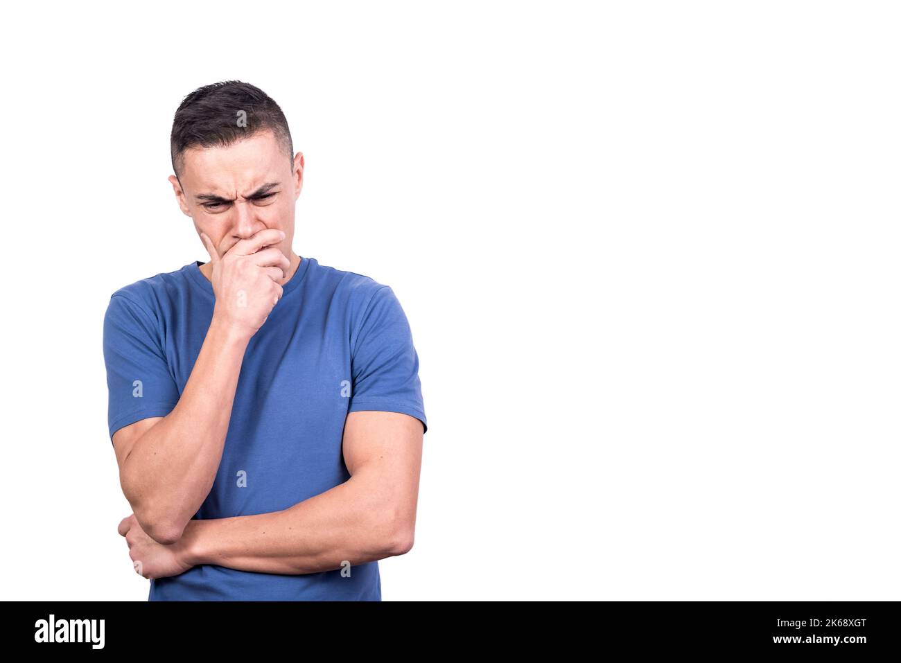 Man with his hand on his face thinking seriously Stock Photo - Alamy