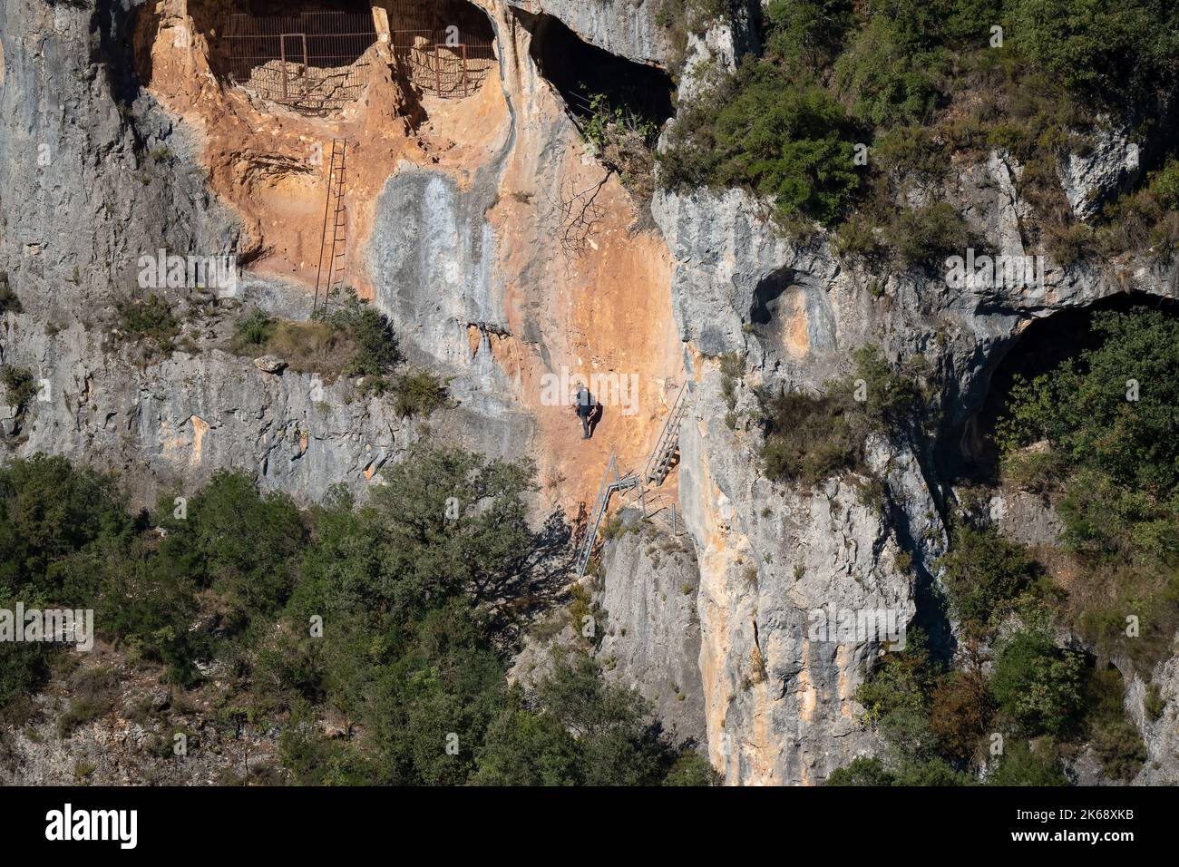 two people exploring the rocky outcrops and caves that are home to ...
