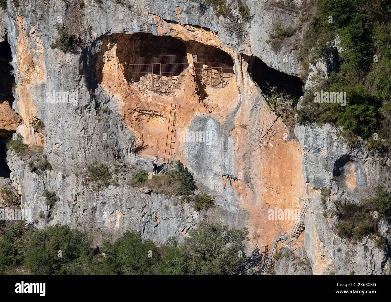 two people exploring the rocky outcrops and caves that are home to ...