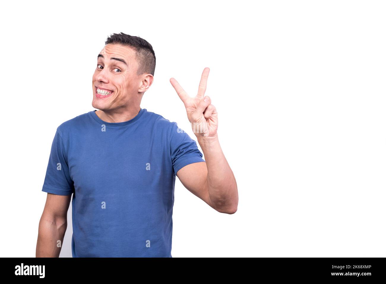 Man raising fingers gesturing victory and success Stock Photo - Alamy