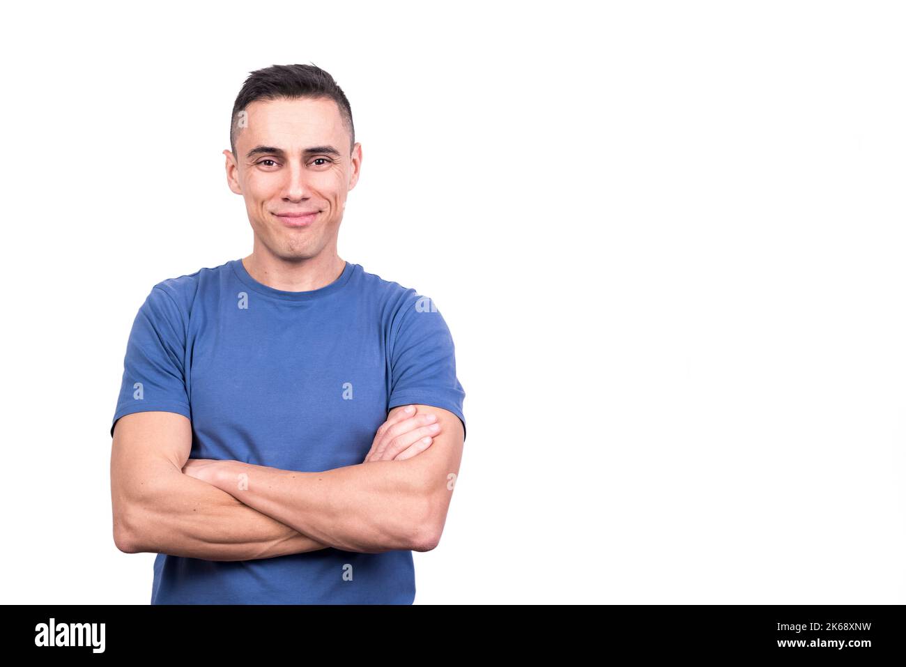 Man standing with arms crossed and proud expression Stock Photo - Alamy