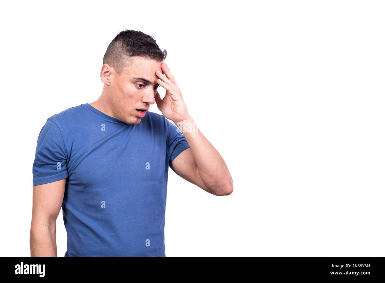 Surprised man looking at the ground covering his face Stock Photo - Alamy