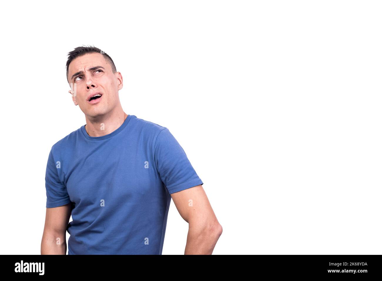 Man looking up with a doubtful expression Stock Photo - Alamy