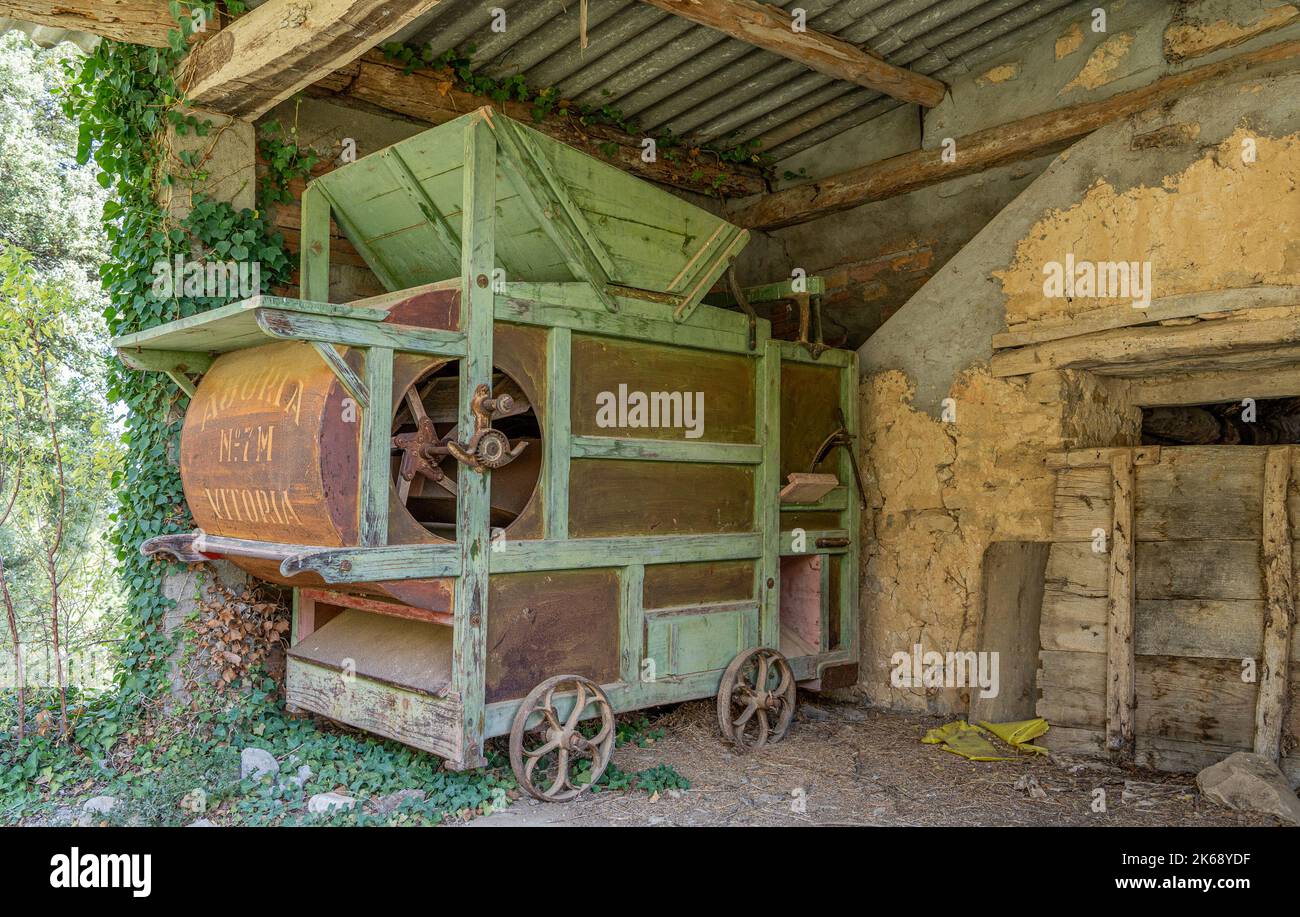 vintage winnowing machine shaded under a building canopy Stock Photo ...