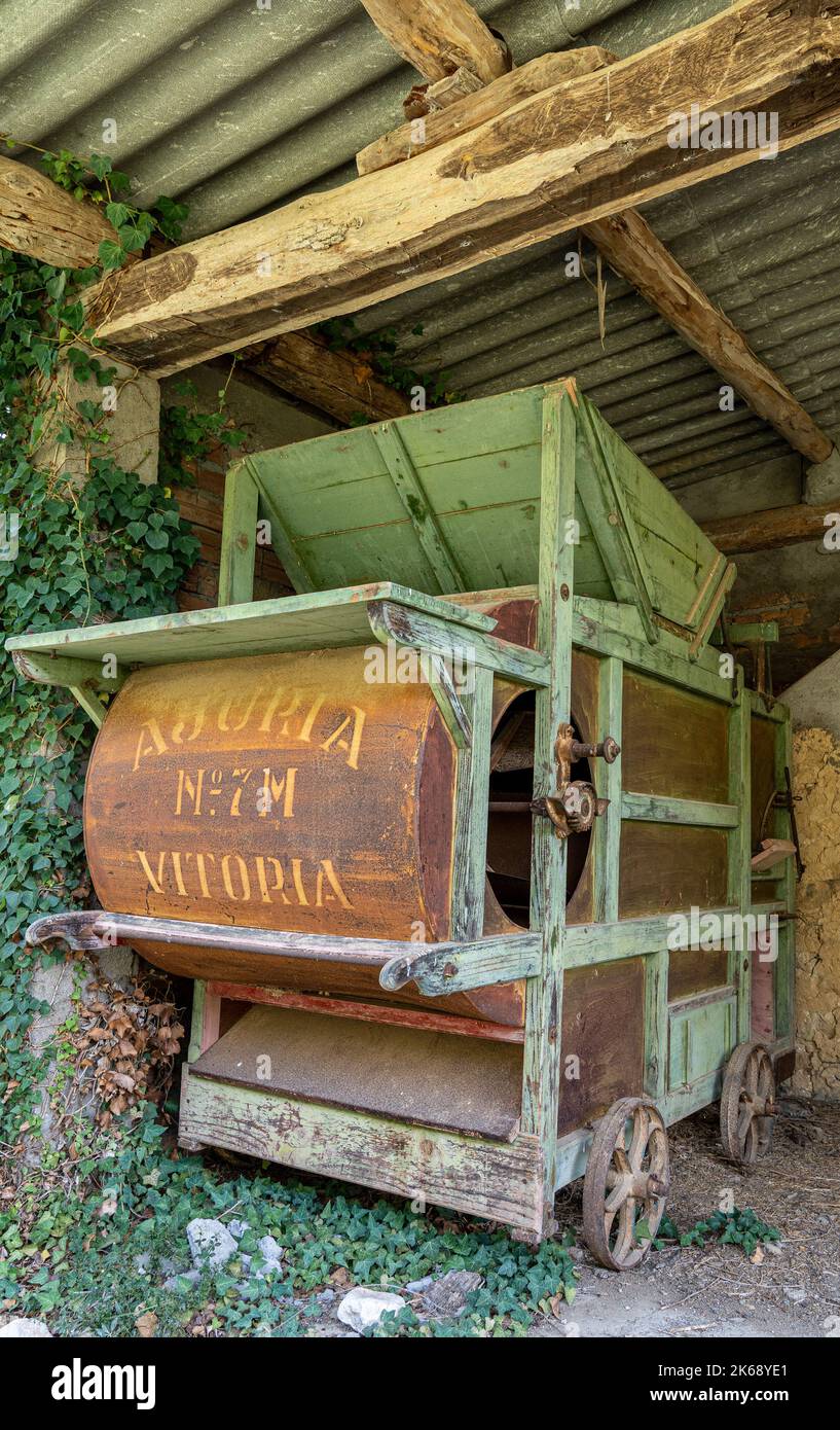 vintage winnowing machine shaded under a building canopy Stock Photo ...