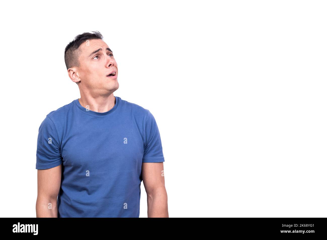 Man looking up with expression of disbelief Stock Photo - Alamy