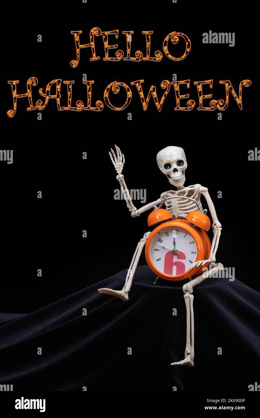 A human skeleton waving his hand, greeting holding an orange alarm ...