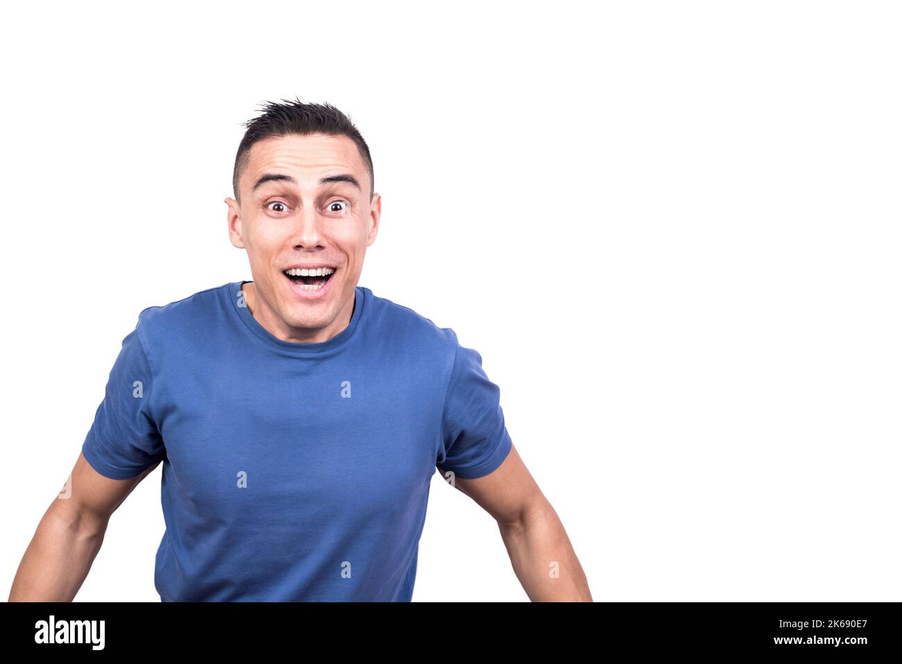 Happy man standing with open eyes while smiling Stock Photo - Alamy