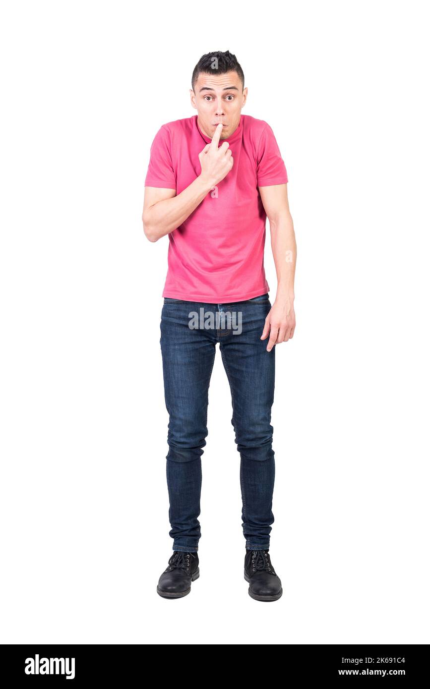 Confused man touching lips and looking at camera Stock Photo - Alamy