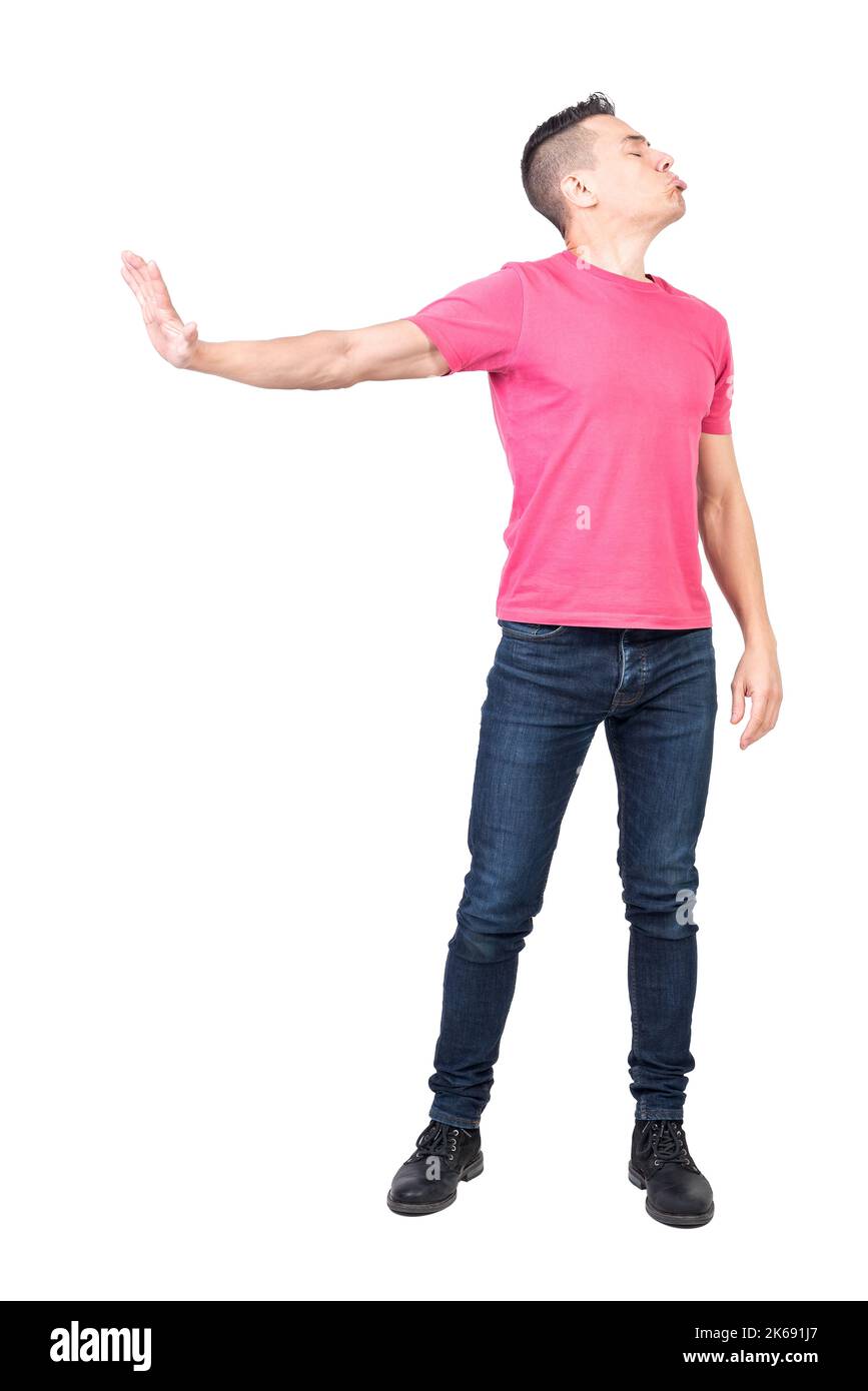 Angry male showing stop gesture and pouting lips in white studio Stock ...