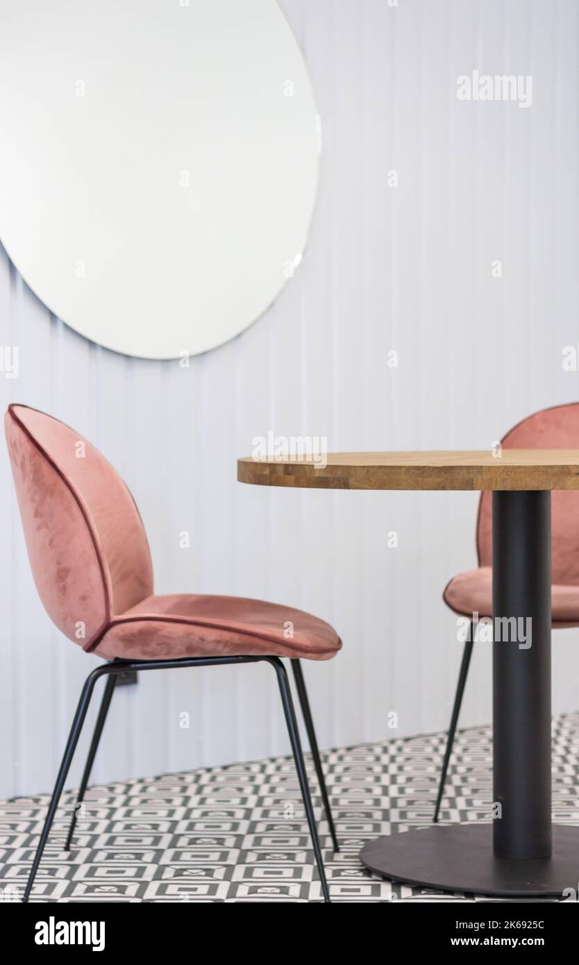 Chairs, wooden table and mirror on the wall. Comfort zone. Cozy cafe ...