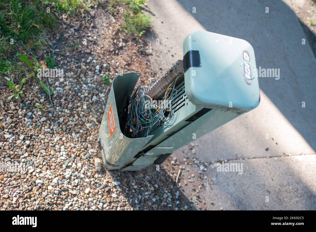 A high angle shot of an old broken communication junction box on a road ...