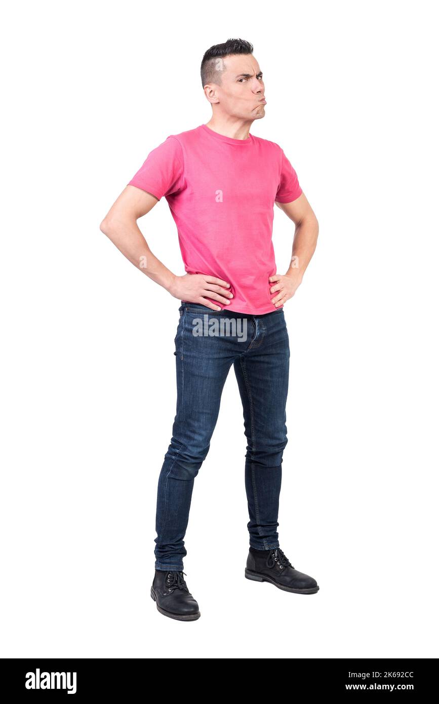 Irritate frowning male standing with hands on waist in studio Stock Photo - Alamy