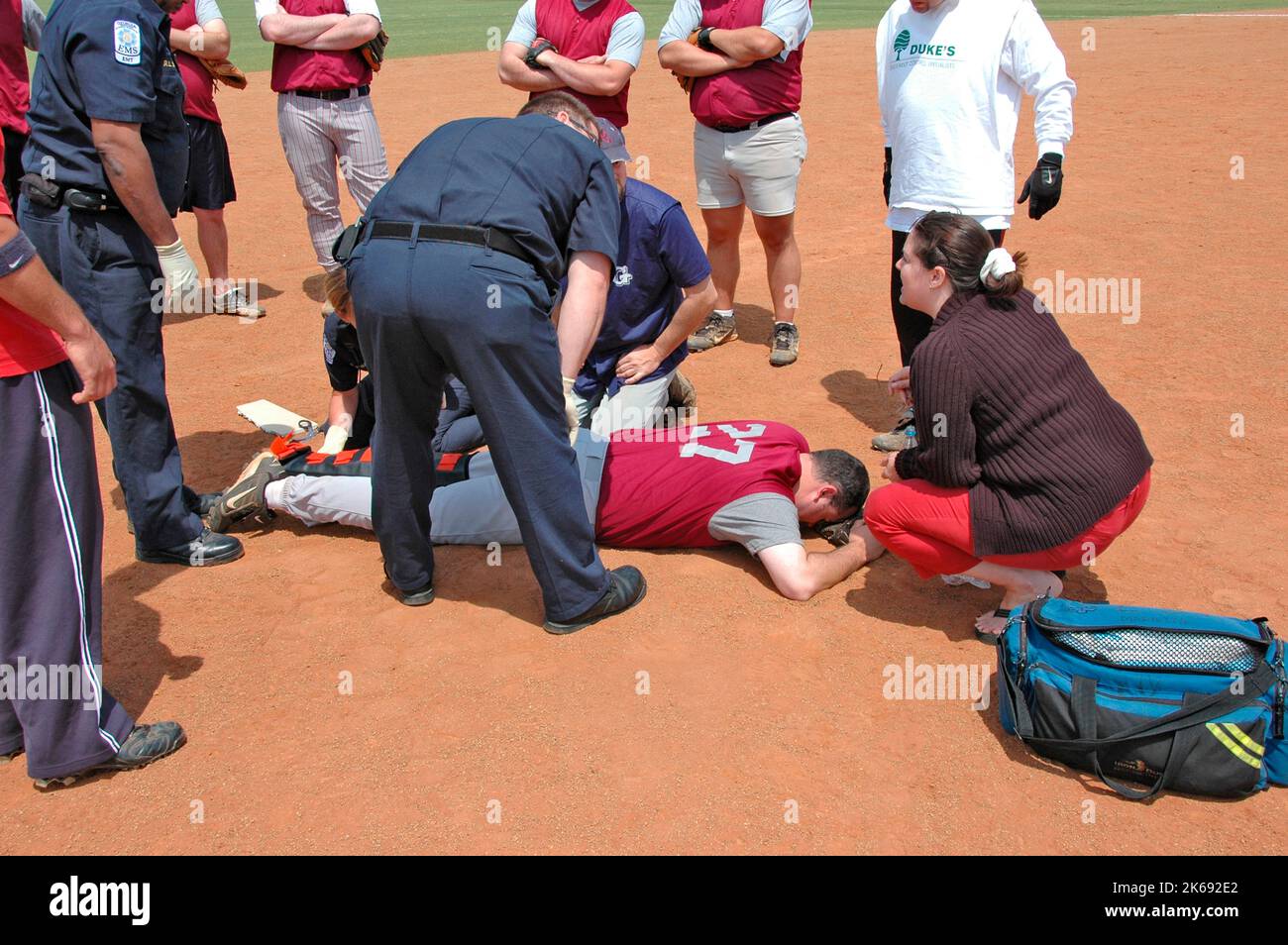 softball Player with broken leg is attended to by fire personal and ...