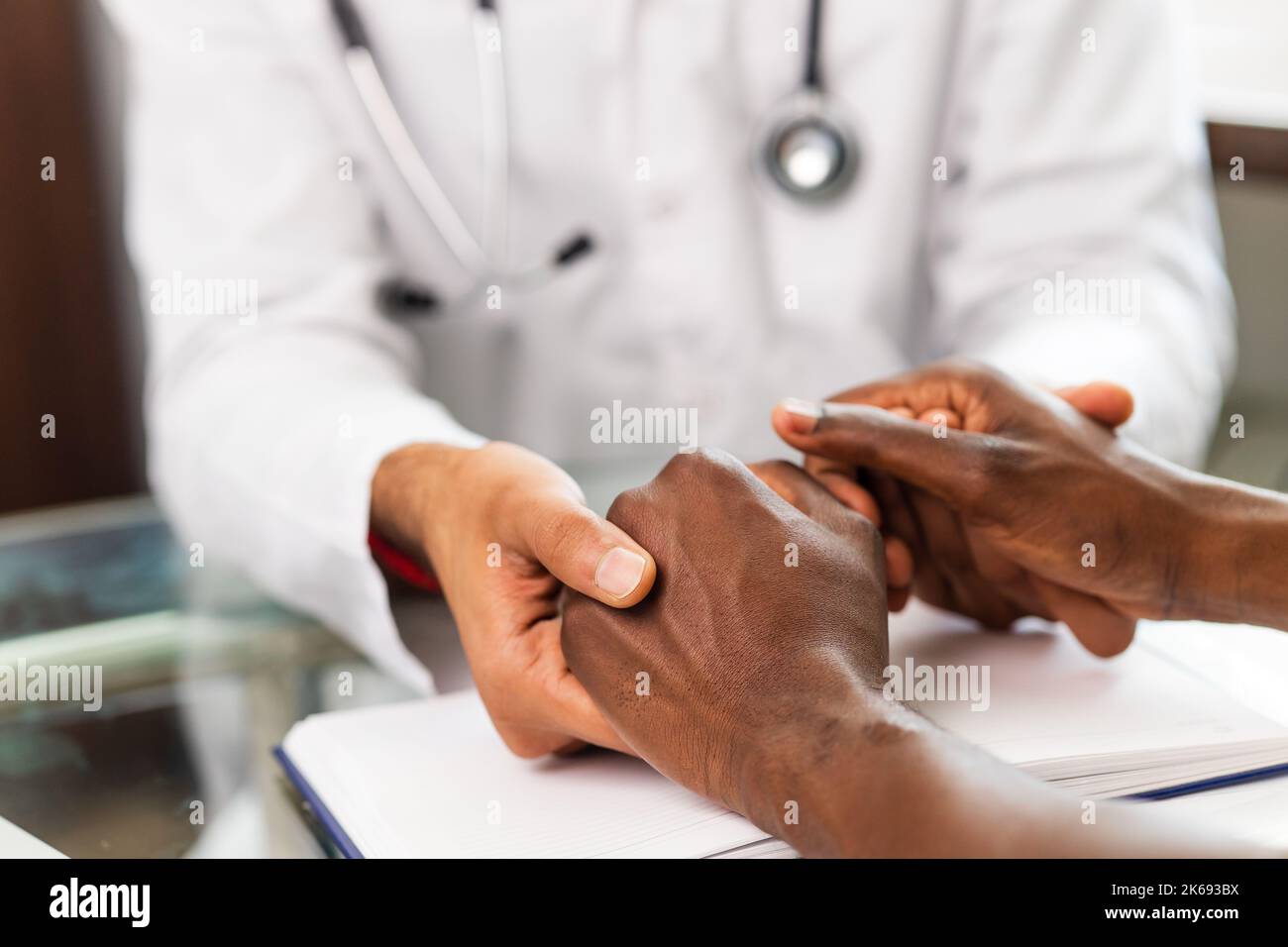 Friendly doctor hands holding patient hand support and hope concept ...