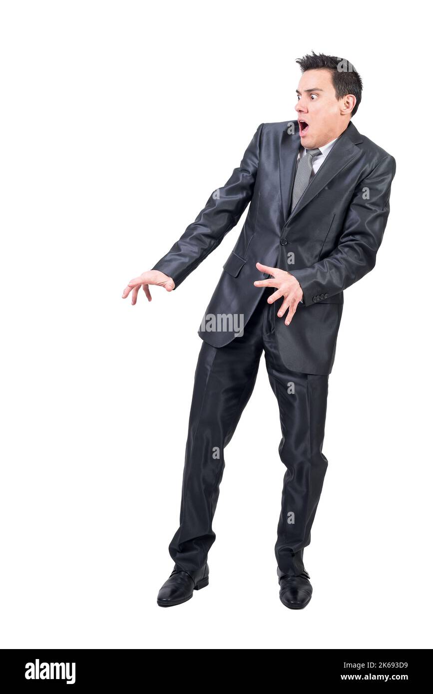 Scared man in suit standing in studio Stock Photo - Alamy