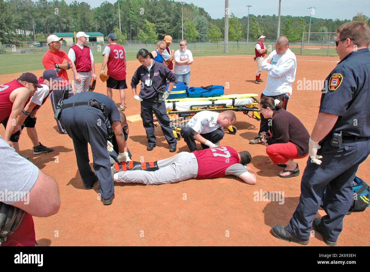 softball Player with broken leg is attended to by fire personal and ...