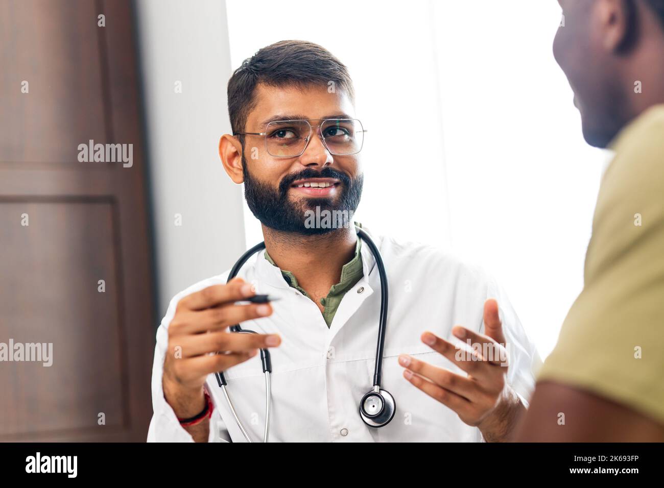 doctor and male patient talking at office consultation for further ...