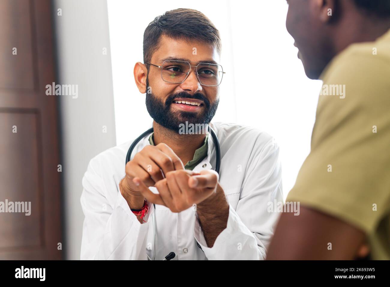 Portrait of indian man doctor talking to patient on consultation Stock ...