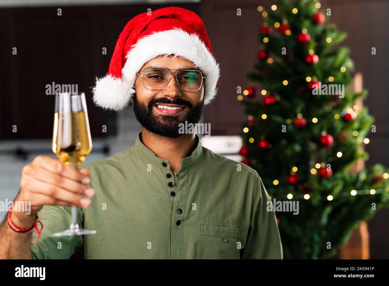 indian man drinking alcohol at home Christmas tree lights garland ...