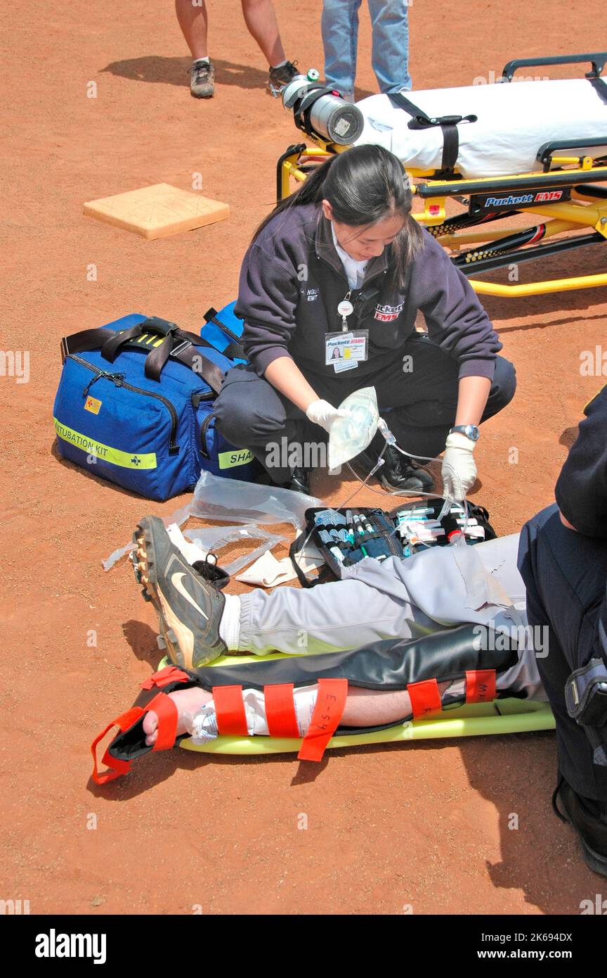 softball Player with broken leg is attended to by fire personal and ...