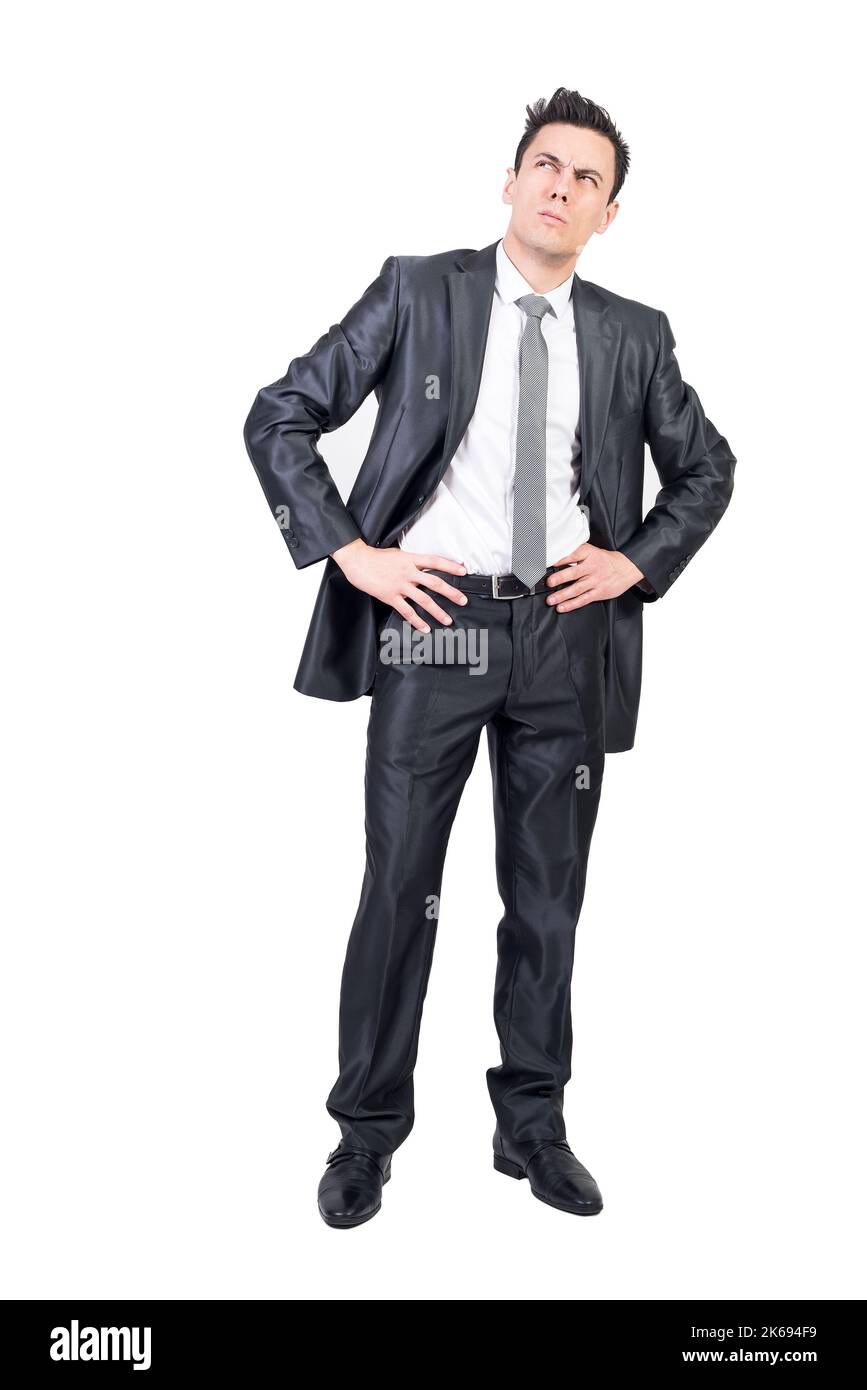 Thoughtful man in formal suit keeping hands on waist Stock Photo - Alamy