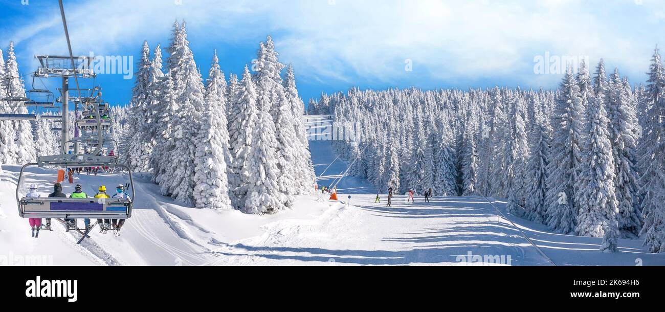 Panorama of ski resort, slope, people on the ski lift, skiers on the ...