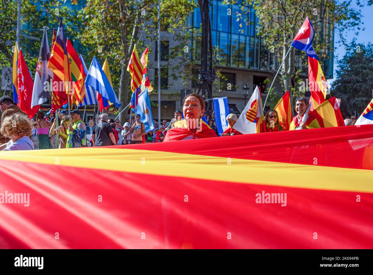 Barcelona, Spain. 12th Oct, 2022. A woman is seen behind a huge Spanish ...