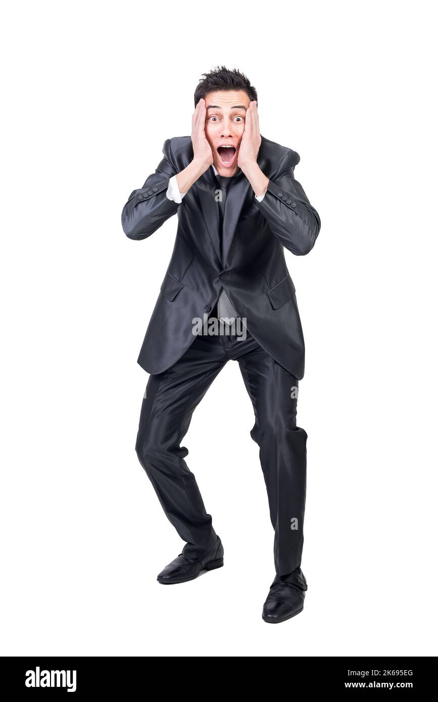 Surprised male manager shouting and touching face in studio Stock Photo ...