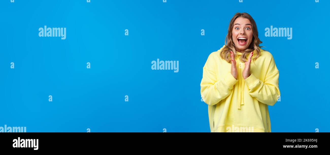 Wow thats awesome. Imrpessed and happy cheerful blond girl clap hands ...