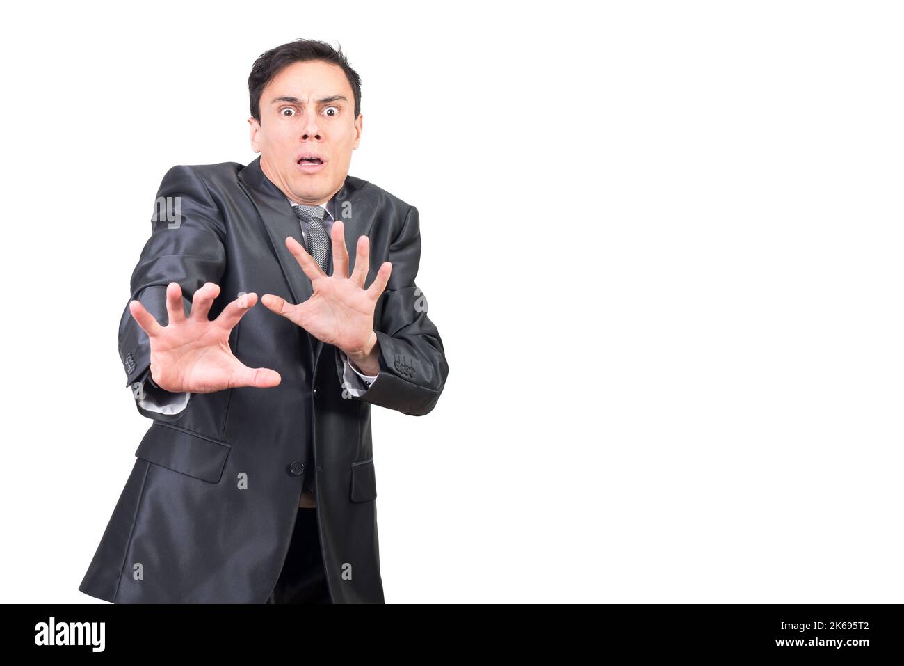 Shocked businessman gesturing and looking at camera with scared face ...