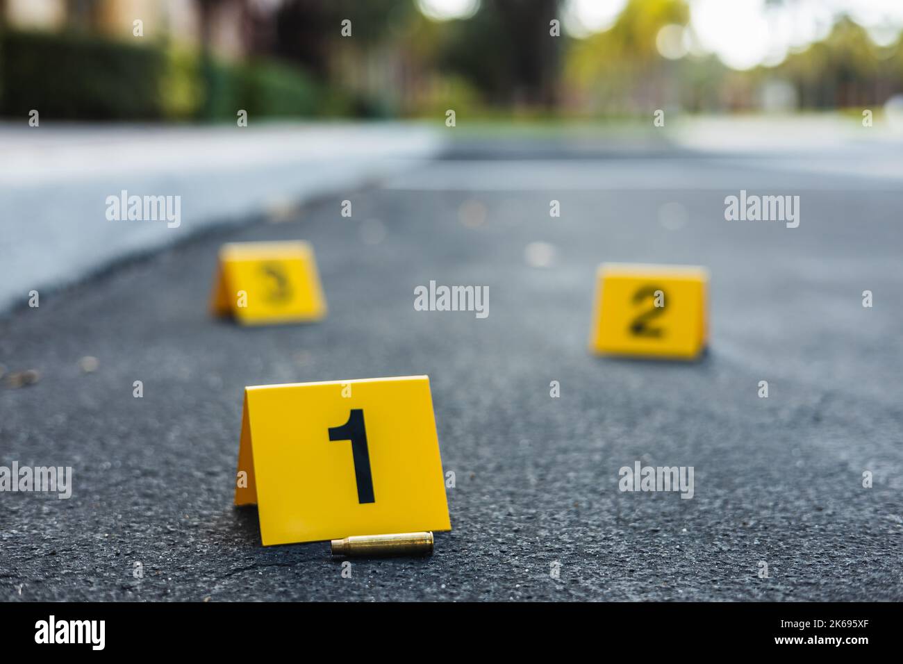 A group of yellow crime scene evidence markers on the street after a ...