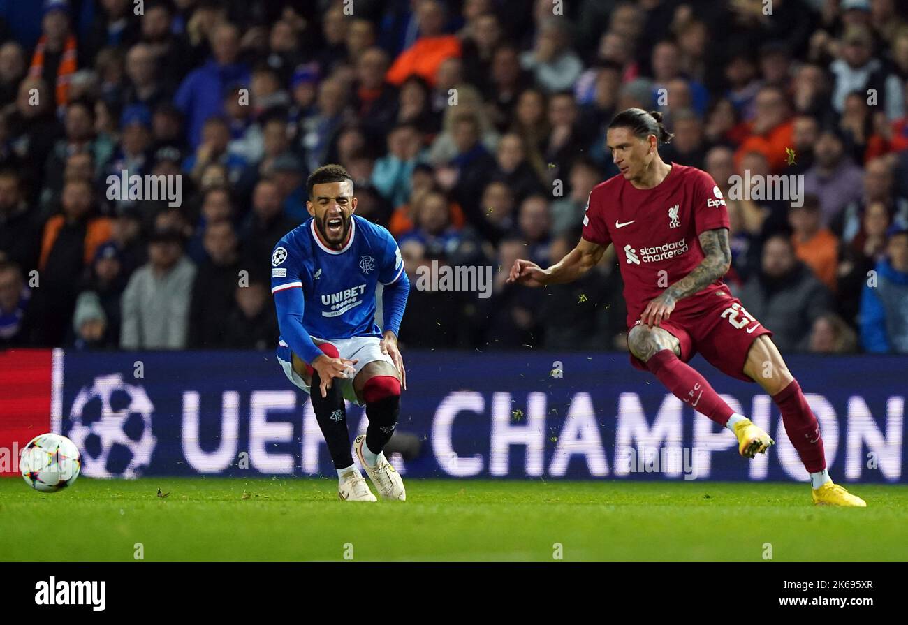 Rangers' Connor Goldson picks up an injury as he challenges Liverpool's ...