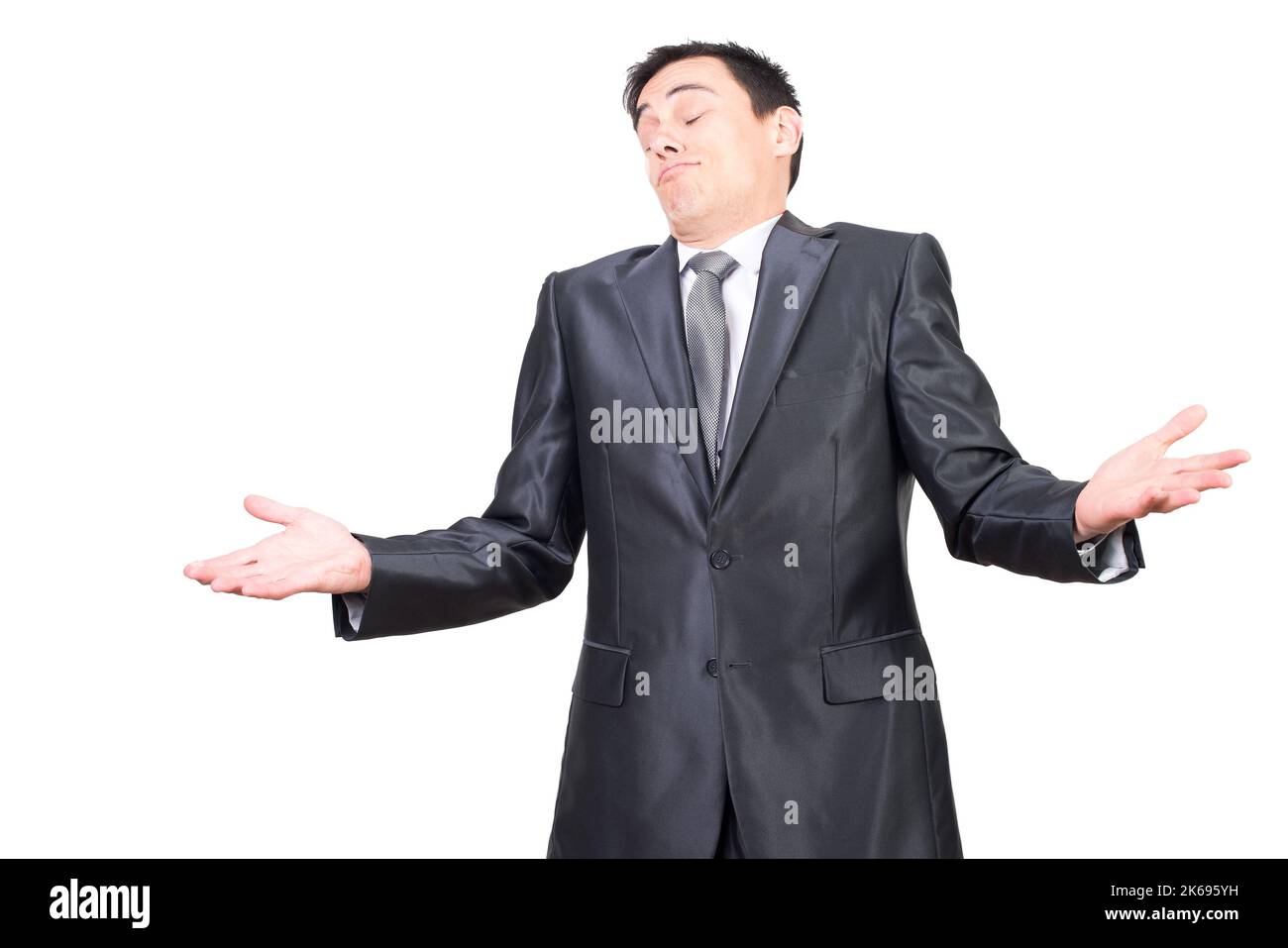 Unsure businessman shrugging shoulders in white studio Stock Photo - Alamy
