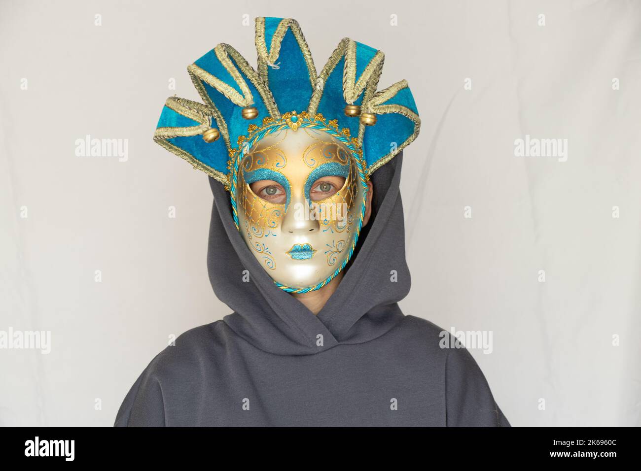 The face of a girl in a Venetian carnival mask on an isolated ...