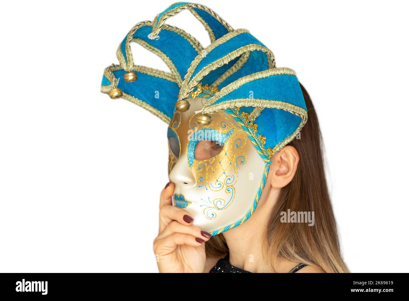 The face of a girl in a Venetian carnival mask on an isolated ...
