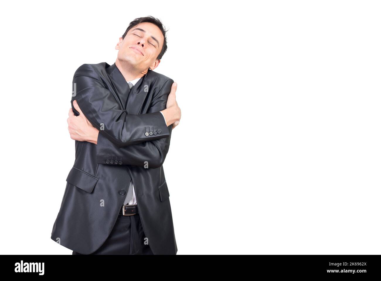 Dreamy man with closed eyes gently embracing himself Stock Photo - Alamy