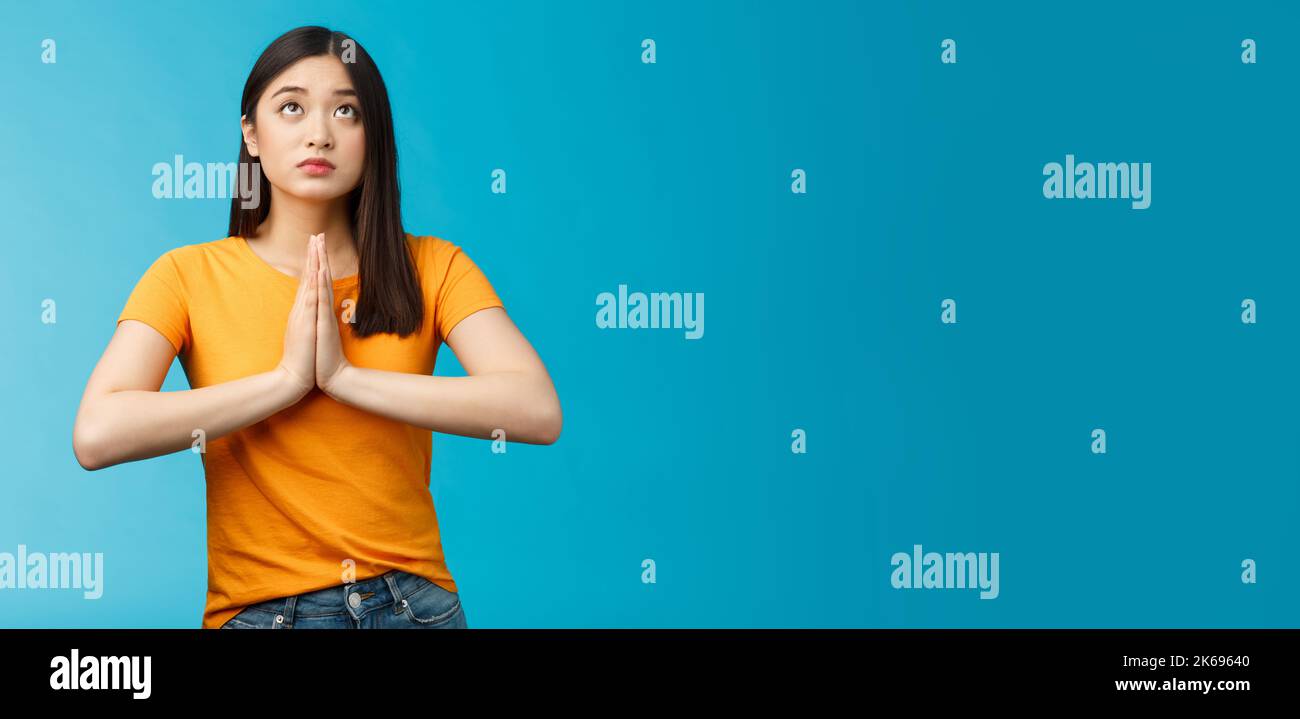 Serious-looking hopeful cute asian woman begging god hear prayers ...