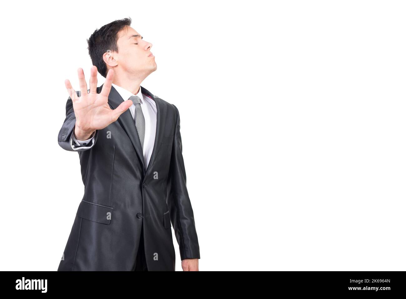 Displeased man showing stop gesture and turning head away Stock Photo ...