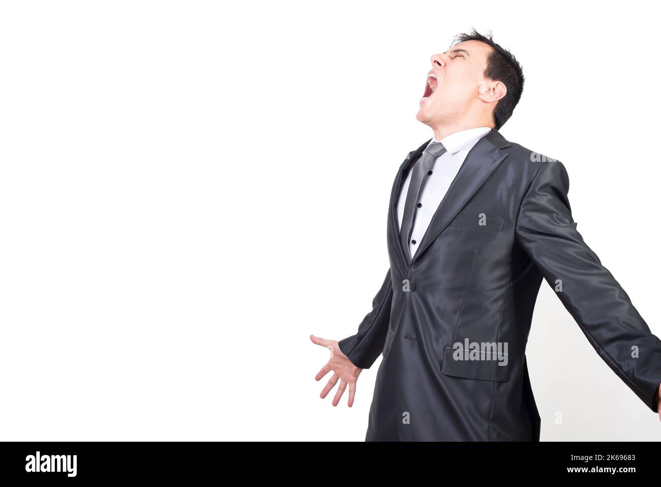 Man in suit outstretching arms and screaming loud Stock Photo - Alamy