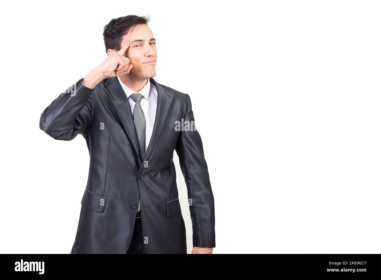 Clever man in suit pointing to head Stock Photo - Alamy