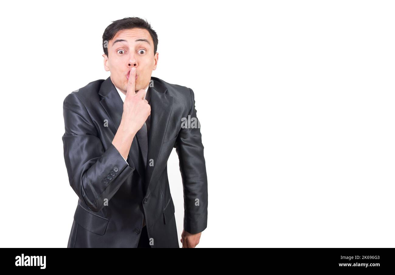 Man in formal suit covering mouth with finger Stock Photo - Alamy