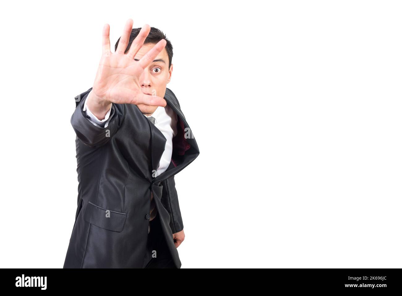 Scared handsome man demonstrating stop gesture in white background ...