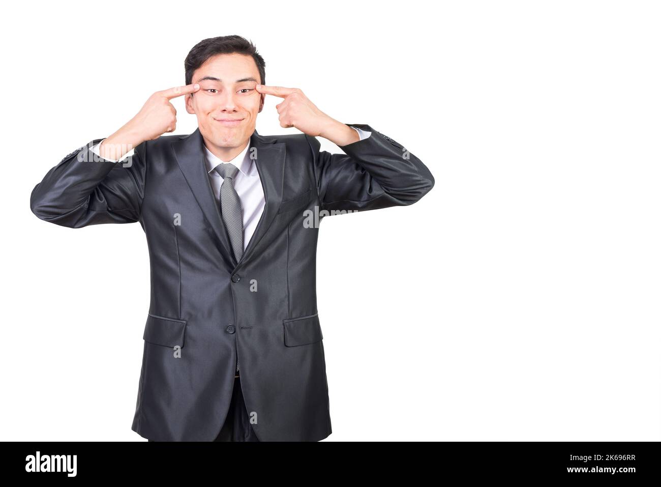 Positive man stretching eyes imitating Chinese eye section Stock Photo ...