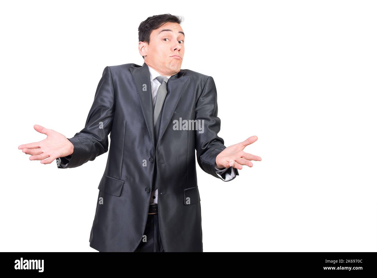 Confused male entrepreneur in suit with raised hands Stock Photo - Alamy